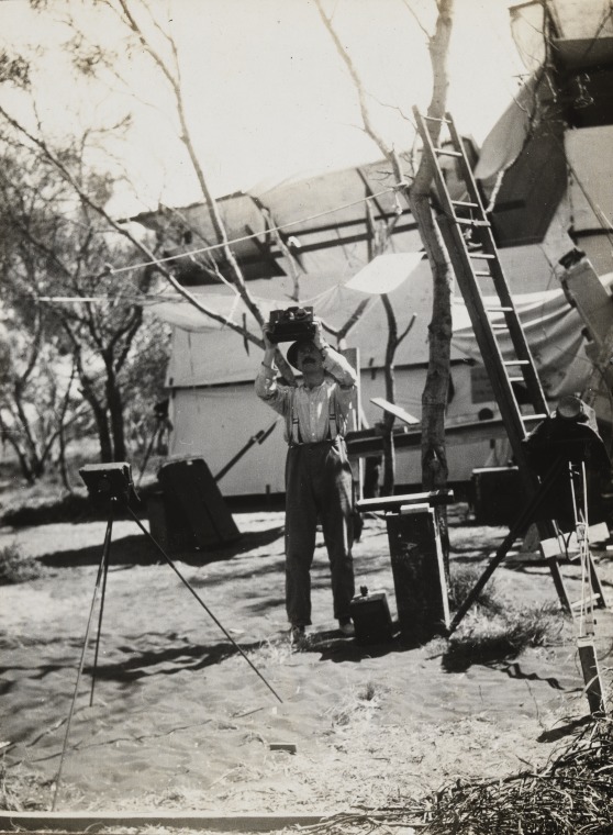 Astronomer photographing the moon's shadow in the air, 1922 Wallal ...