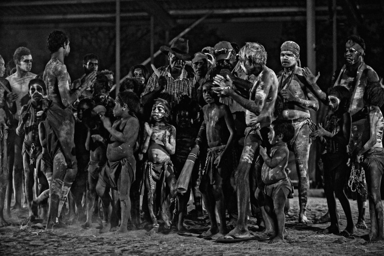 Men and boys prepare for their performance in a corroboree at the ...