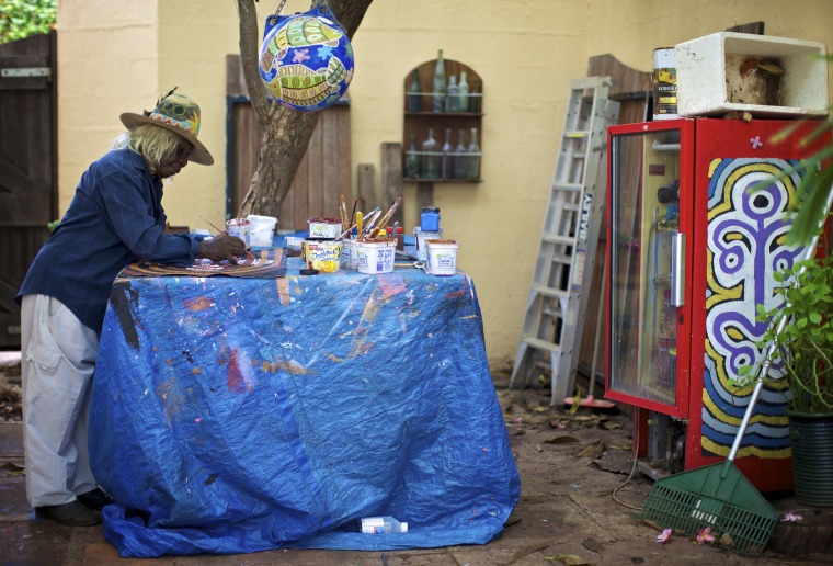 Bardi Jawi artist Bruce Wiggan painting in his studio, One Arm Point ...