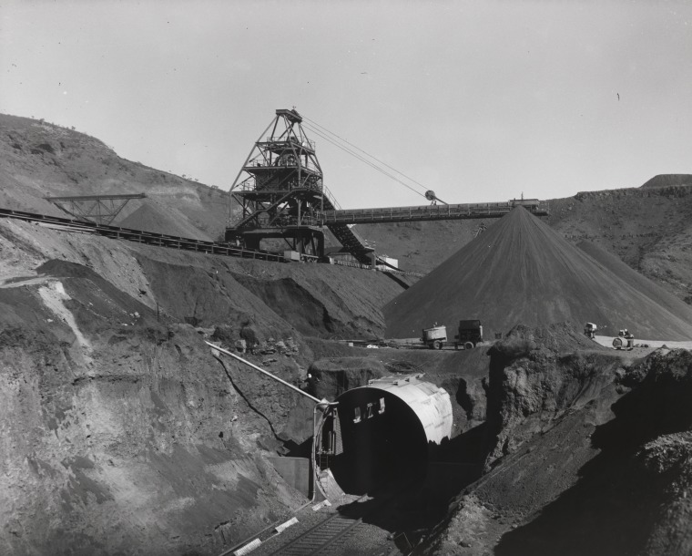Stacker piling iron ore over the rail load out tunnel at Mt Tom Price ...