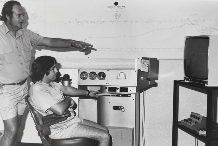 Locomotive driver instructor Ken Onley points out something on the ...