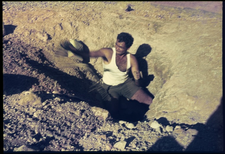 Aboriginal Christian evangelist Ron Williams digging a hole, Western ...