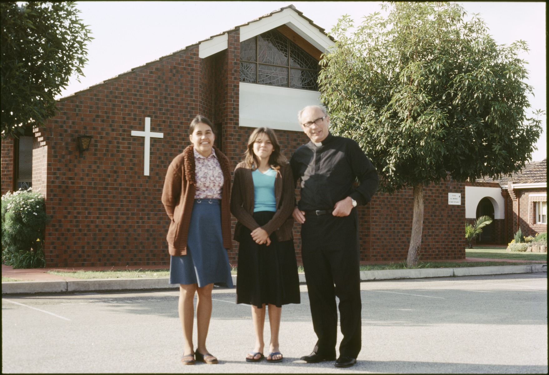 Rosita and Caroline Lovell with Father Luemmen outside the church at ...