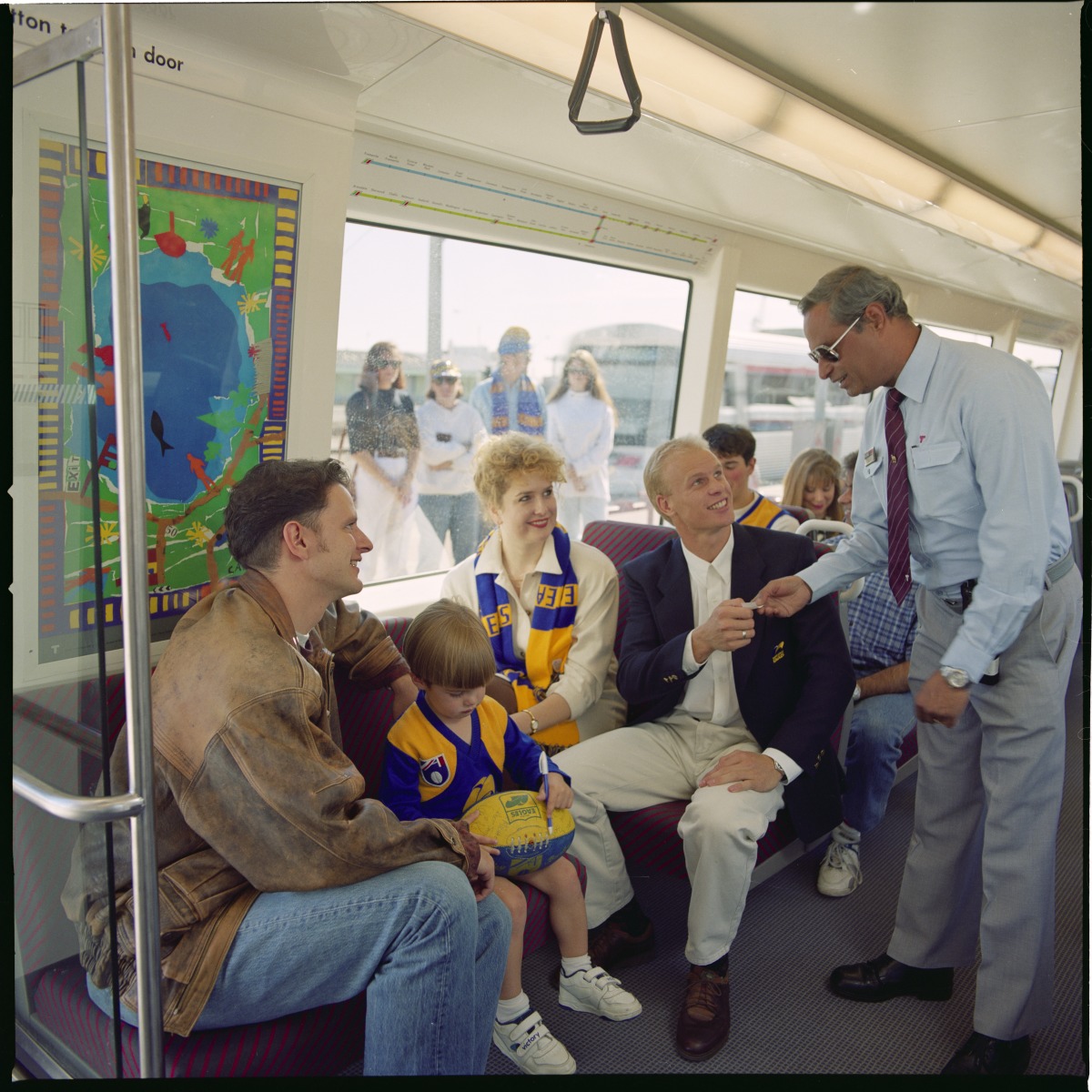West Coast Eagle Dean Kemp with a family catching a bus to the football ...
