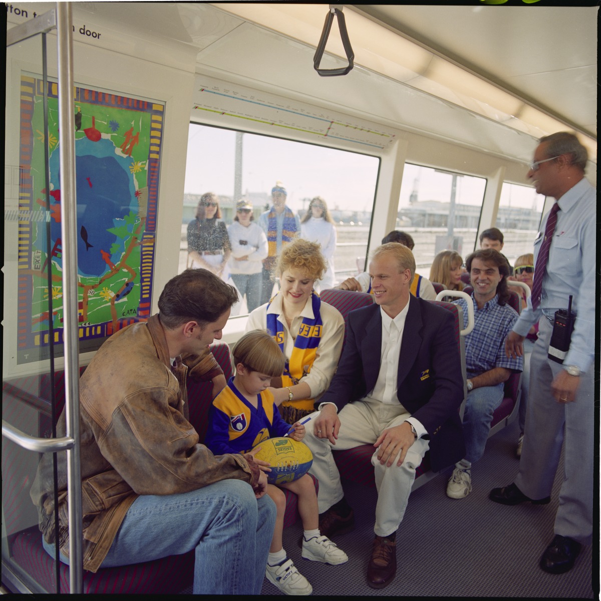 West Coast Eagle Dean Kemp with a family catching a bus to the football ...