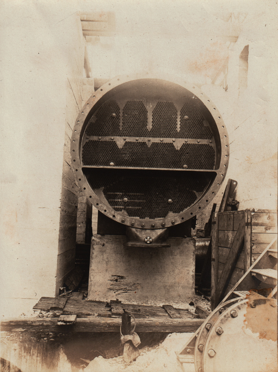 A steam tube boiler with end exposed, possibly in the old east or west ...