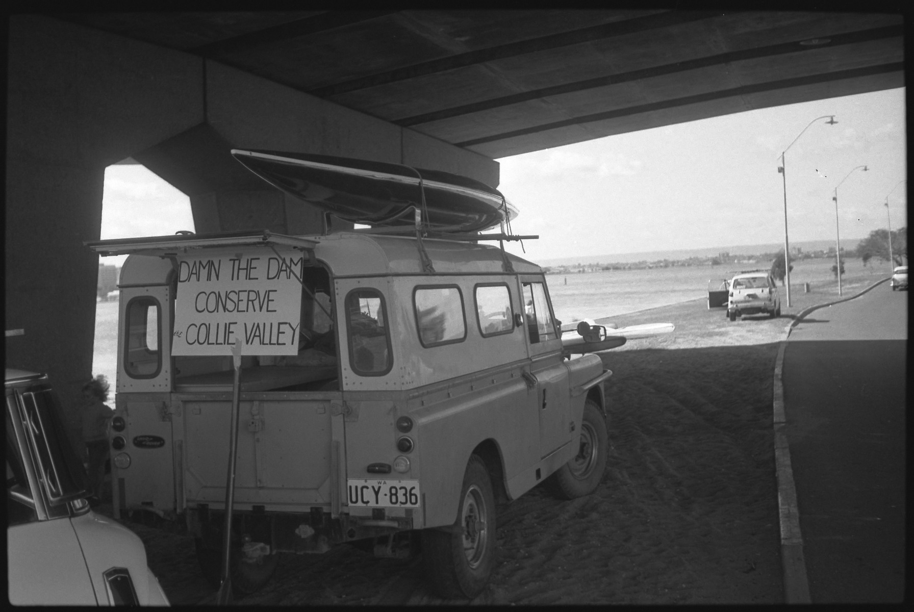Land Rover with canoe on roof and sign (possibly) opposing the Glen ...